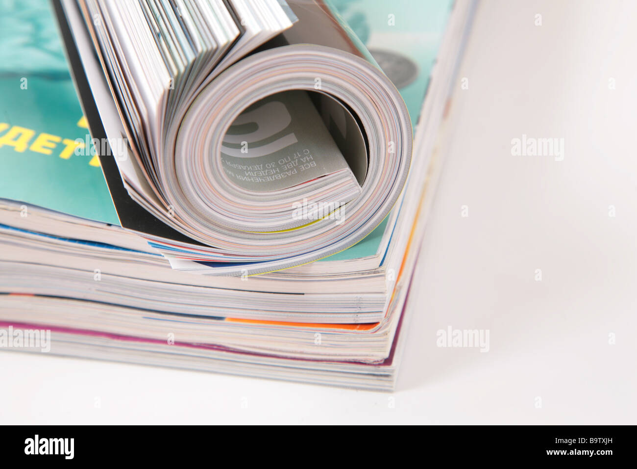 curled magazined on stack Stock Photo - Alamy