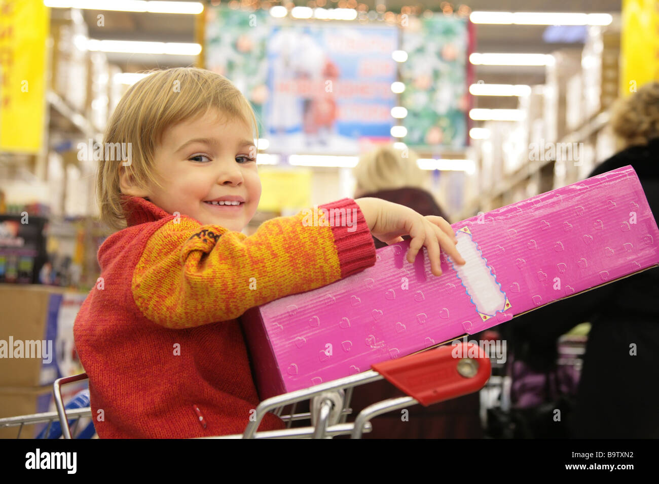 girl with box in store Stock Photo - Alamy