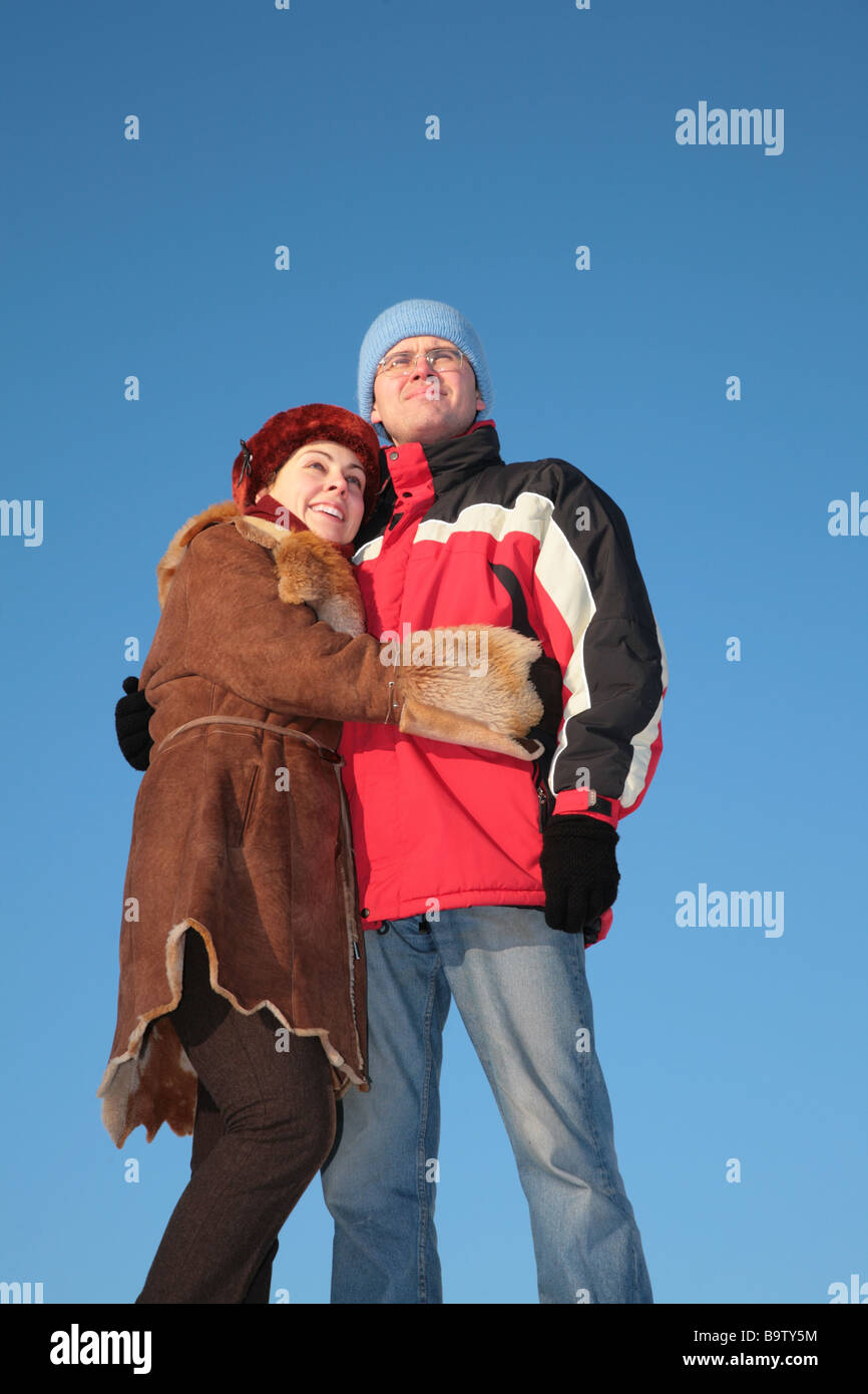 couple against blue sky background in winter Stock Photo - Alamy