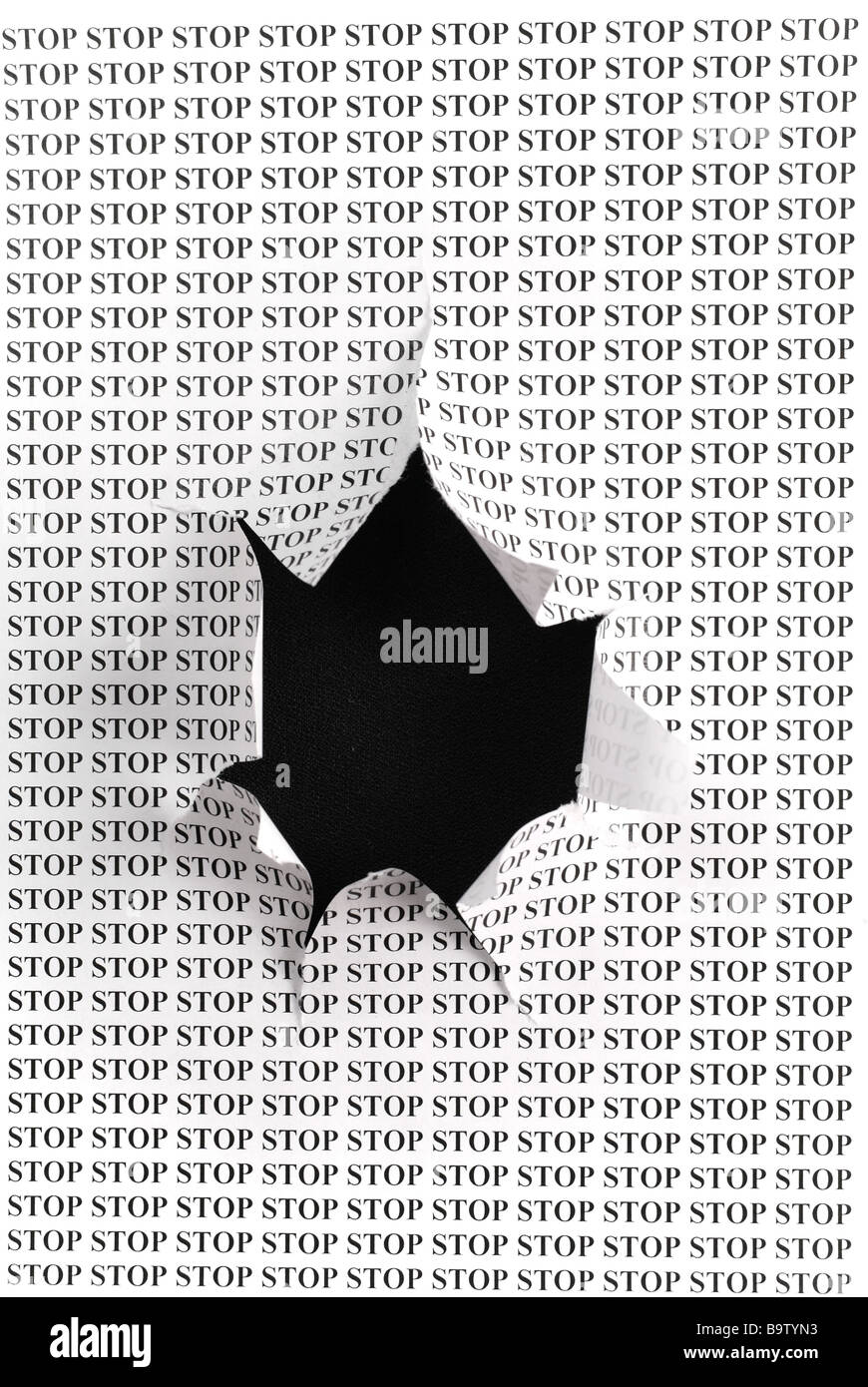 the sheet of paper with printing word stop and the cut hole against the ...