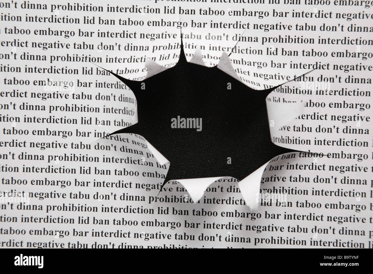 sheet of paper with printing text and cut hole against black background ...