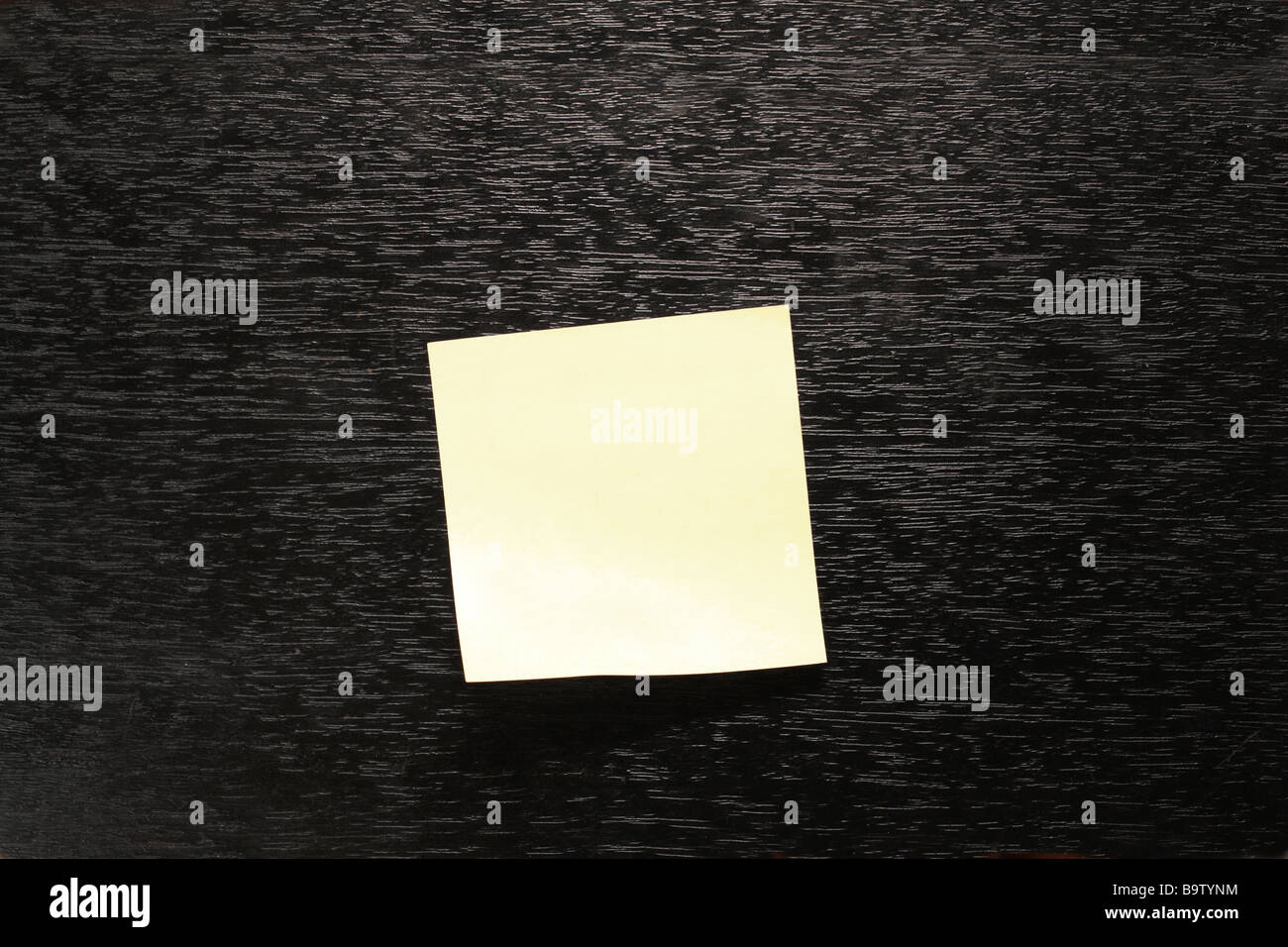 yellow paper sticker on black background Stock Photo - Alamy
