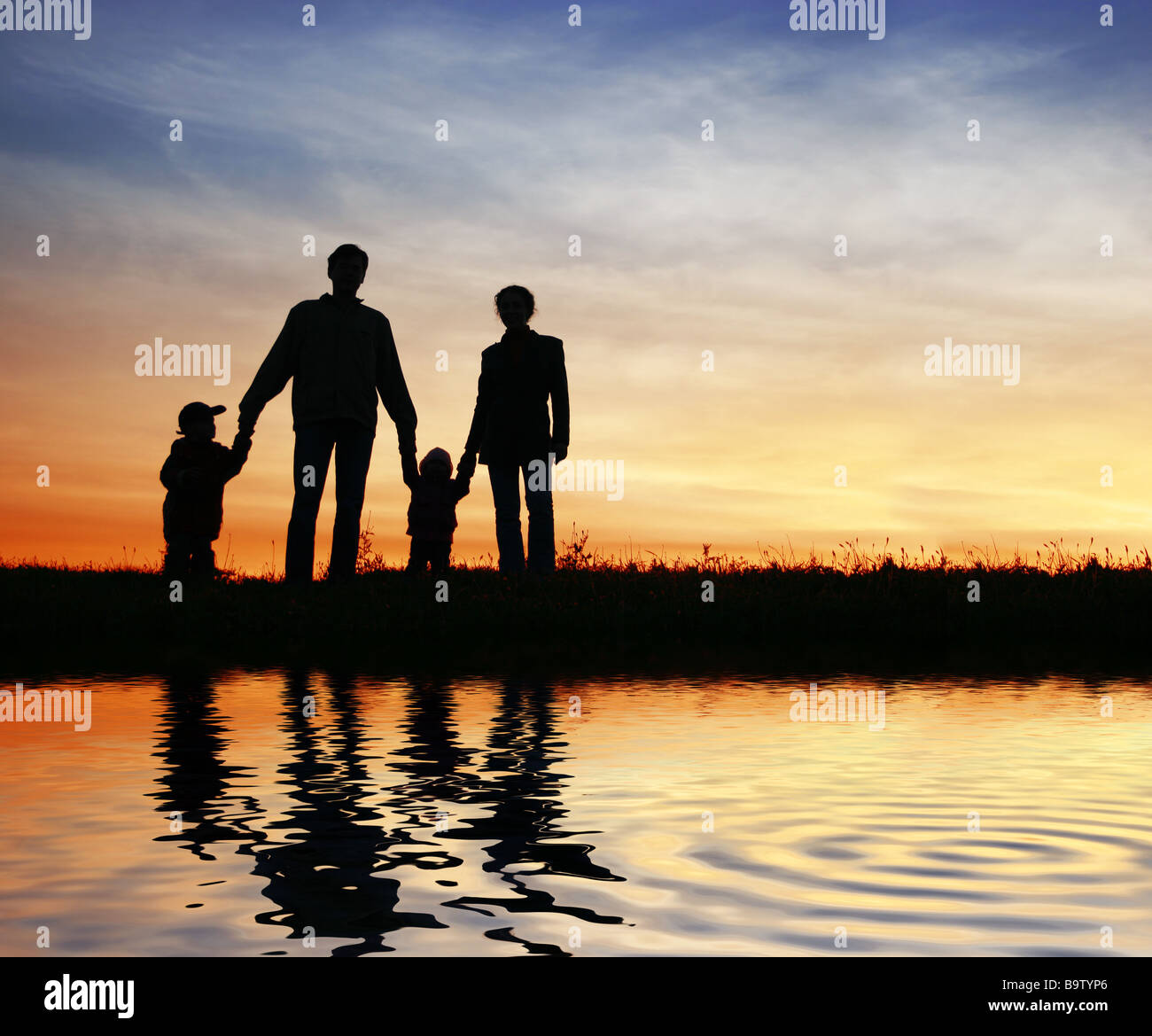 family of four on sunset sky, water Stock Photo - Alamy