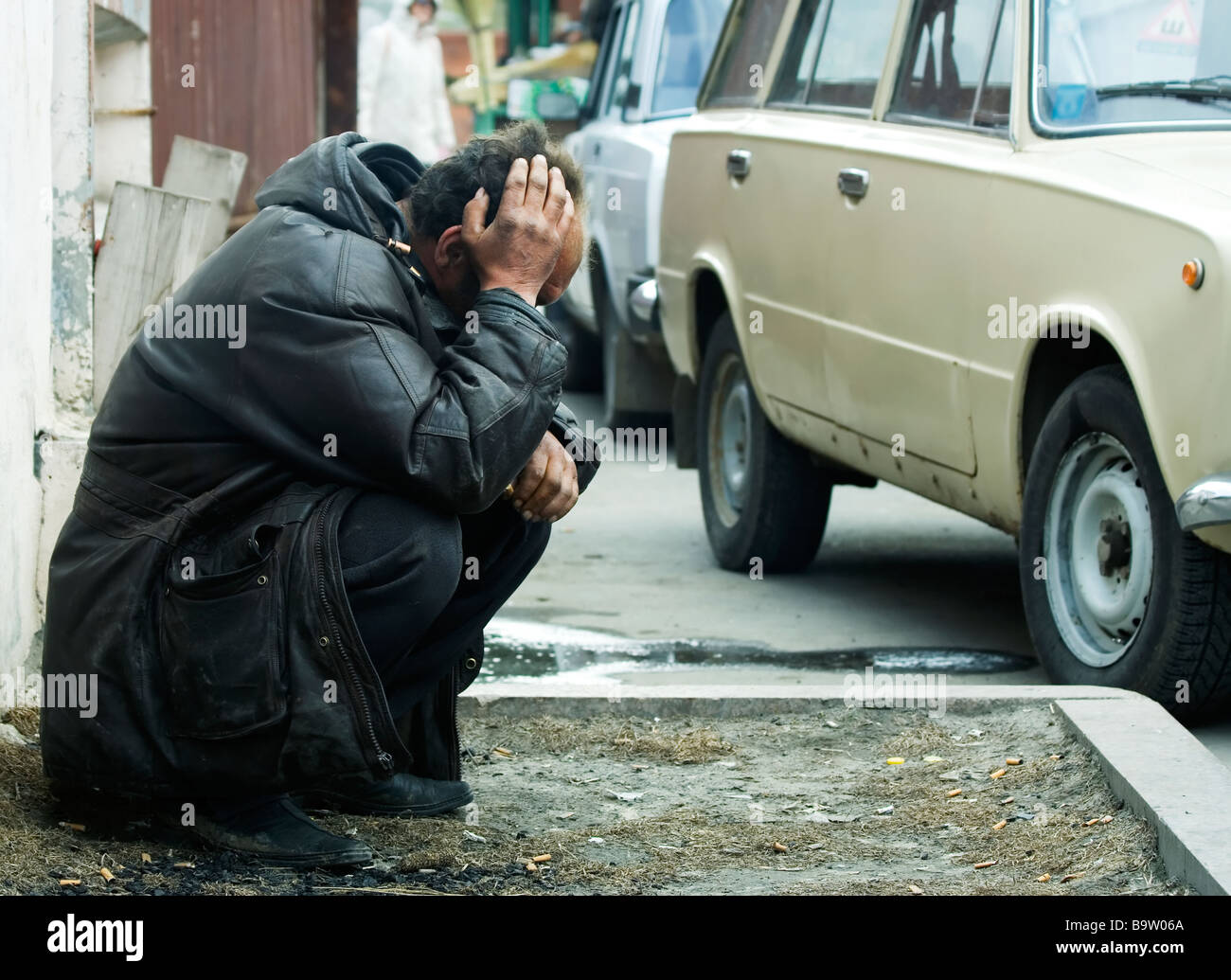 Despair of the homeless man Stock Photo - Alamy