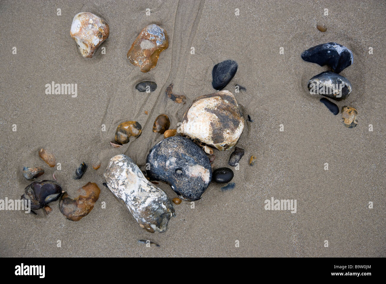 Pebbles in Sand on a Beach Stock Photo - Alamy