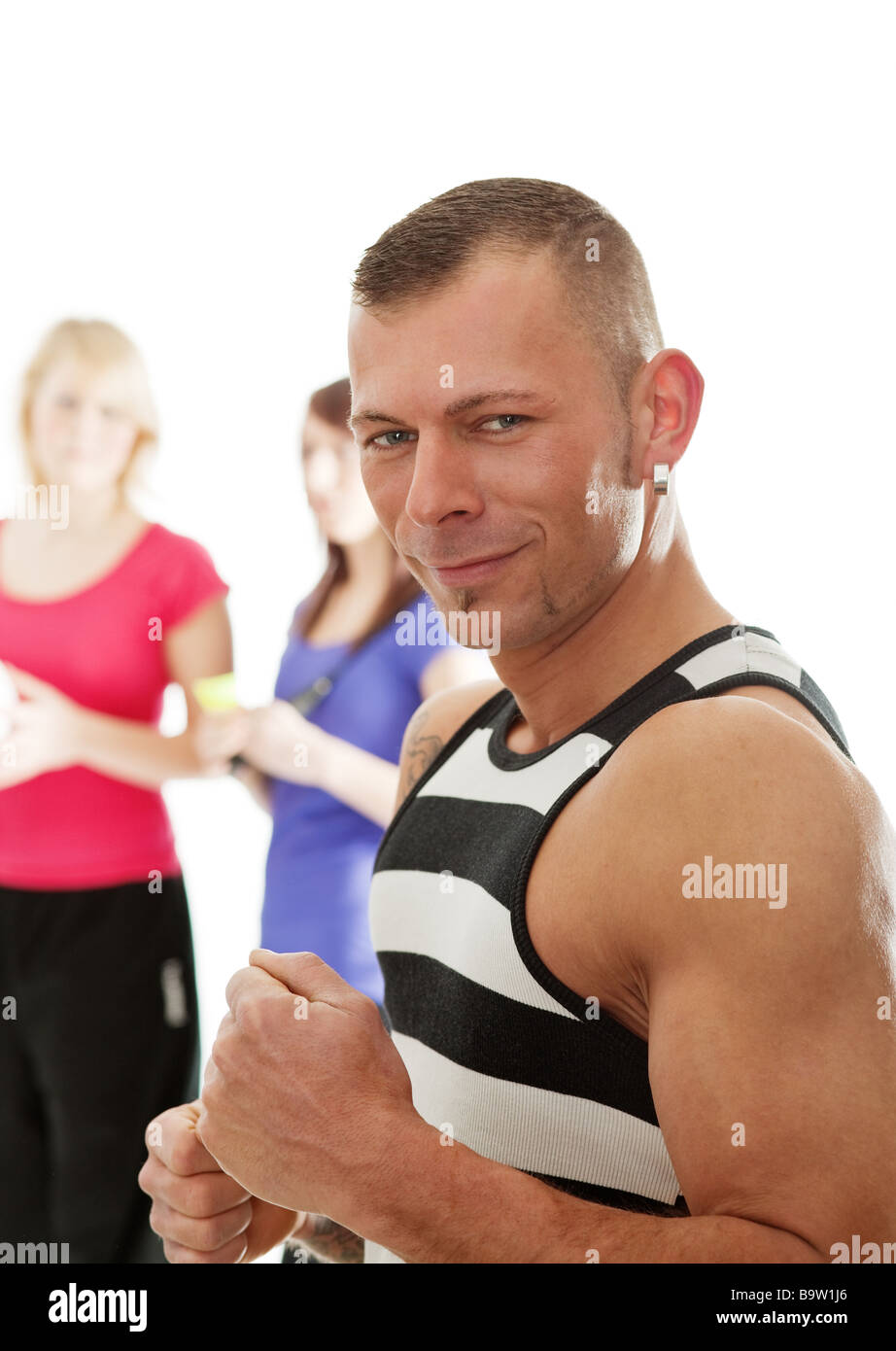 Group of sportive people muscular man on the foreground blurred girls ...