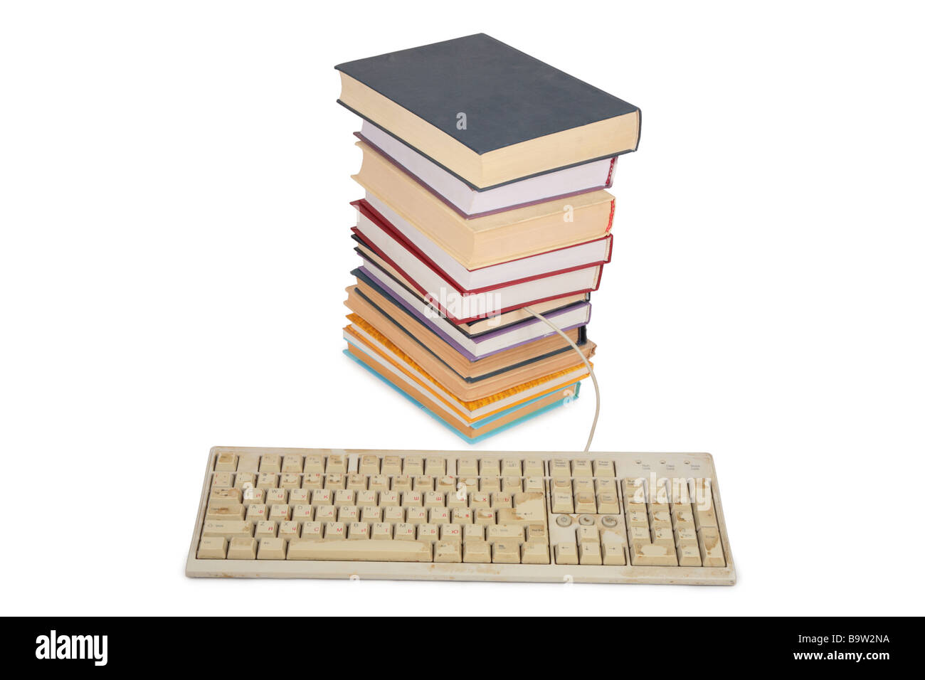 Stack of books with a connected white old dirty keyboard Stock Photo ...