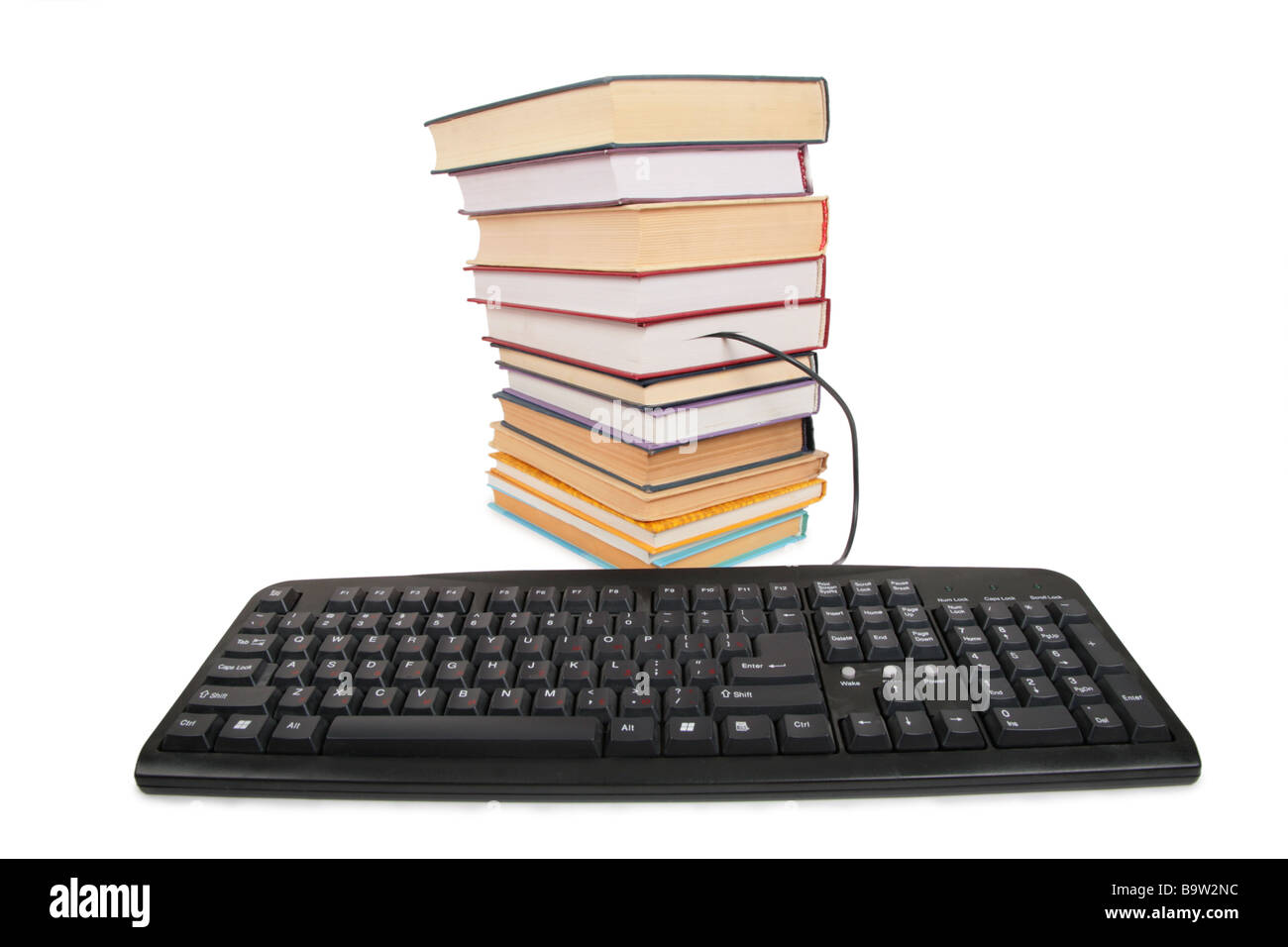 Stack of books with a connected black keyboard Stock Photo - Alamy