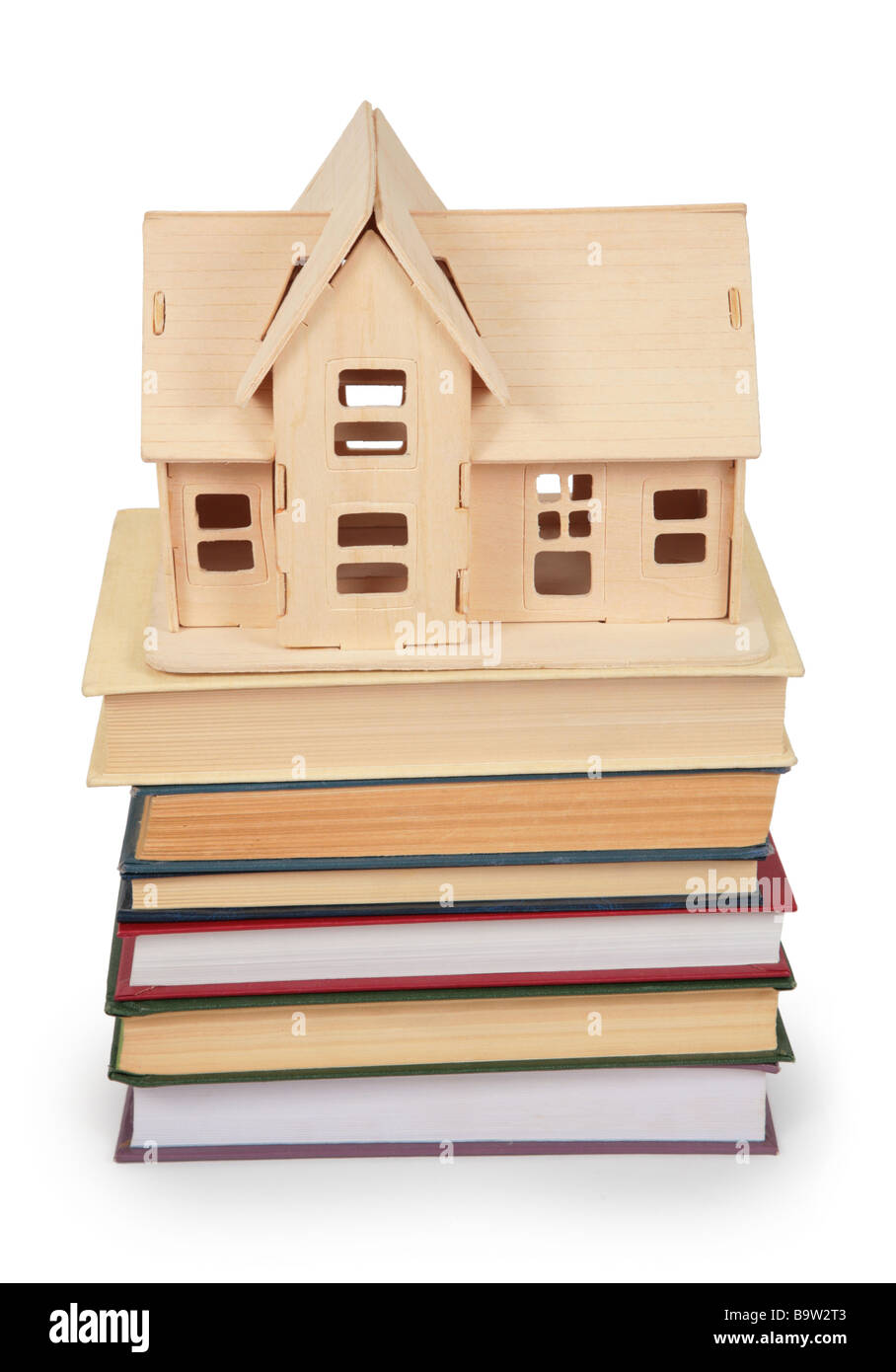toy house on pile of books Stock Photo - Alamy