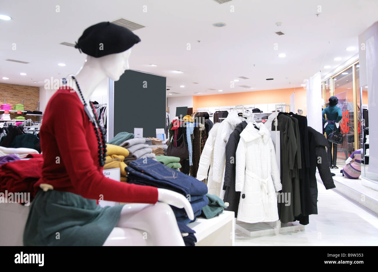 mannequin and upper clothes in shop. focus on middle plan Stock Photo ...