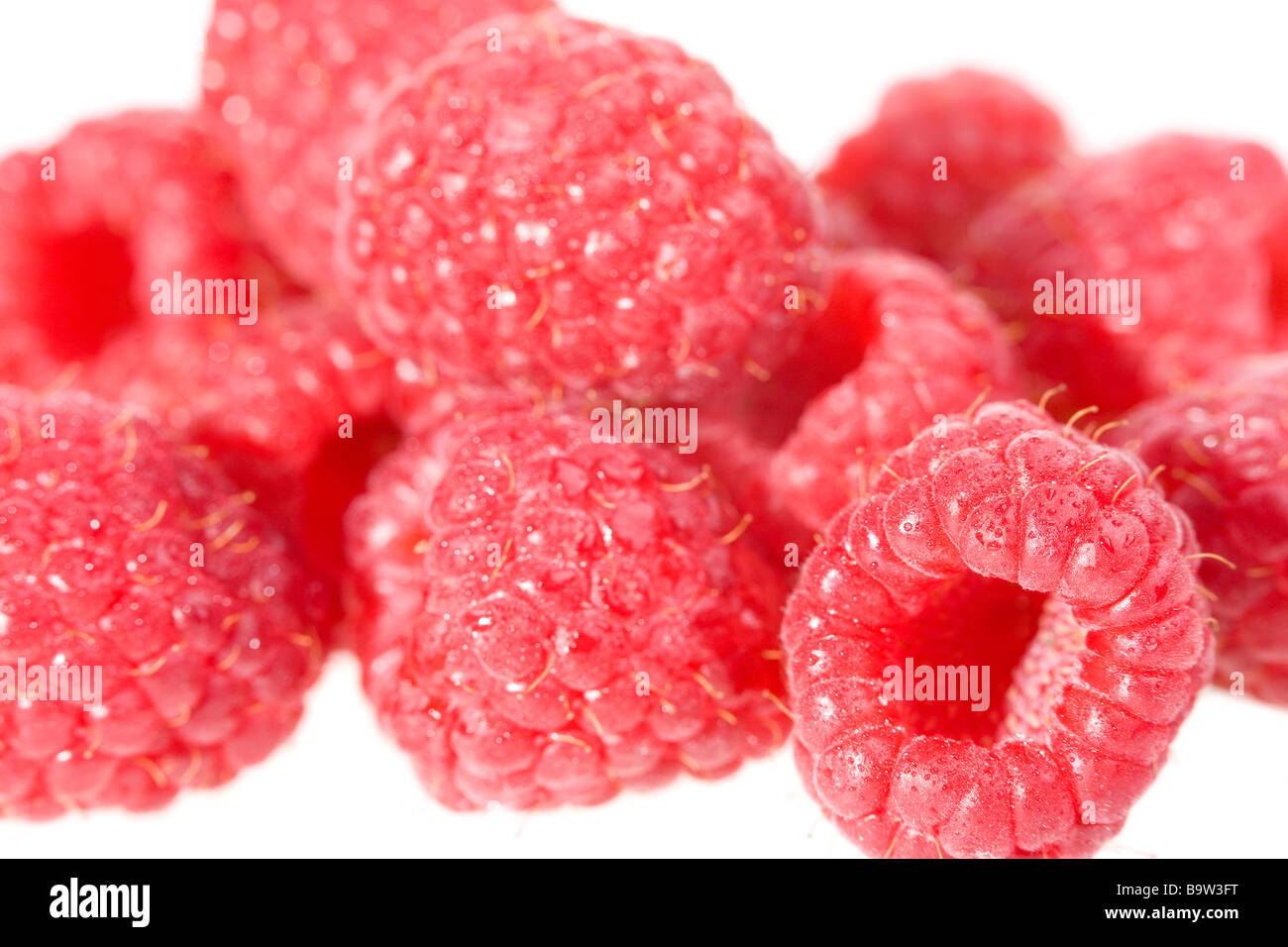 pile of raspberries isolated on white background Stock Photo - Alamy