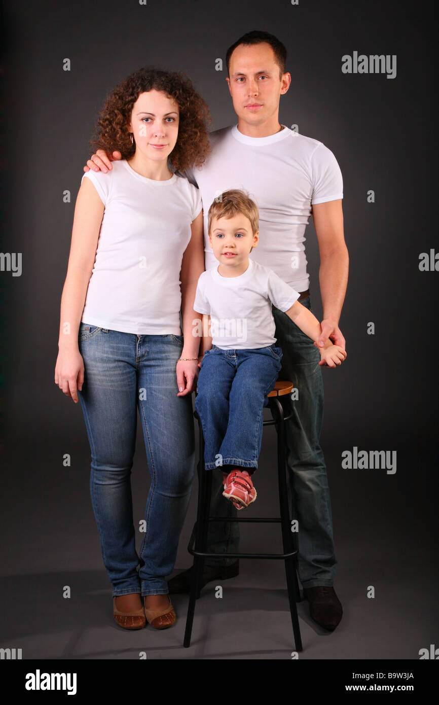portrait of family in studio against dark background Stock Photo - Alamy