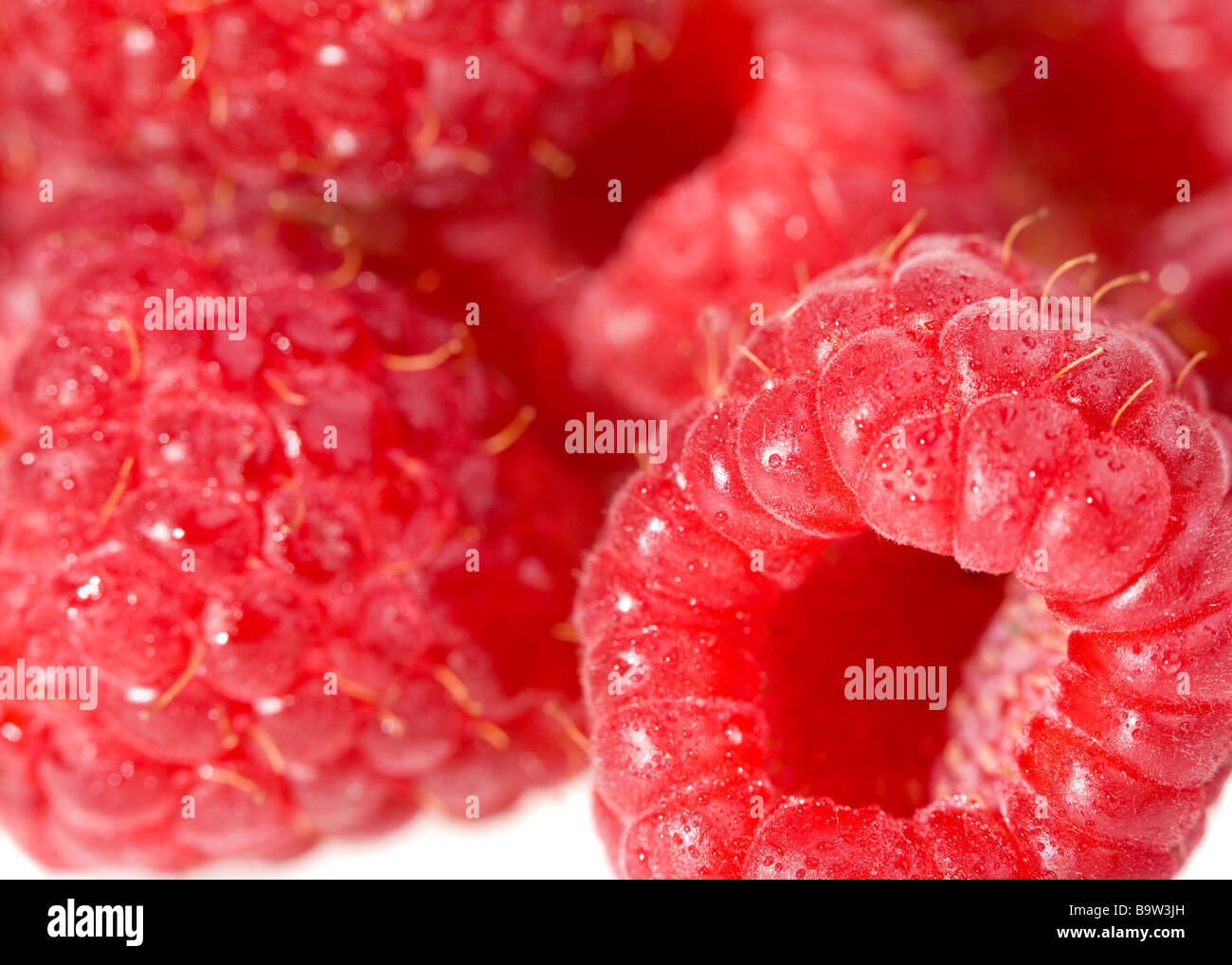 pile of raspberries isolated on white background Stock Photo - Alamy