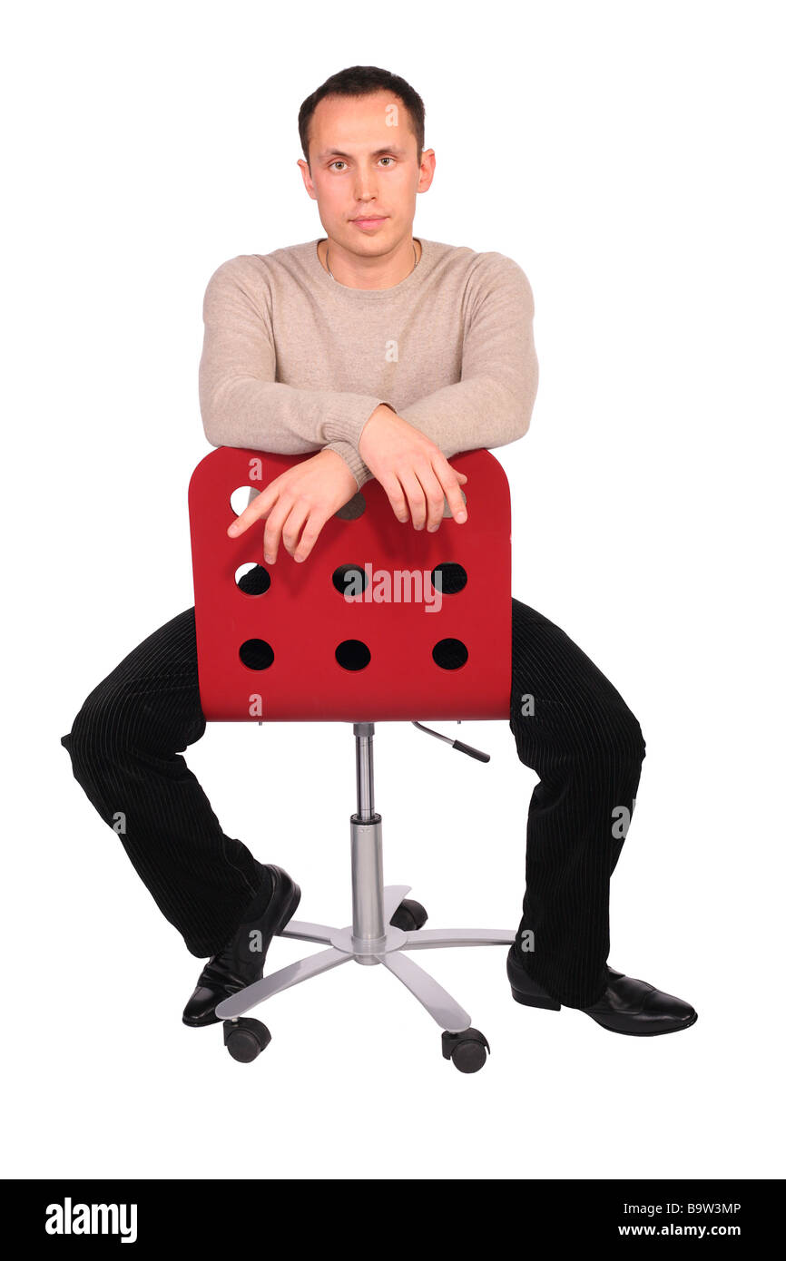 Young man sits on red chair Stock Photo - Alamy