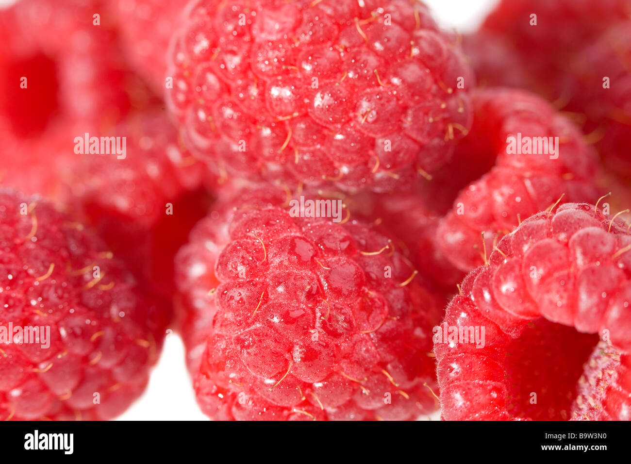 pile of raspberries isolated on white background Stock Photo - Alamy