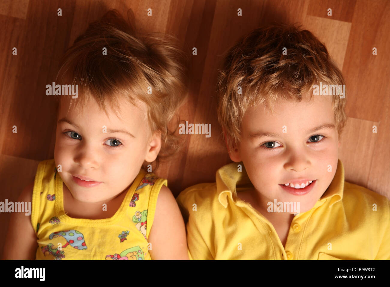 two children lie on the floor Stock Photo - Alamy