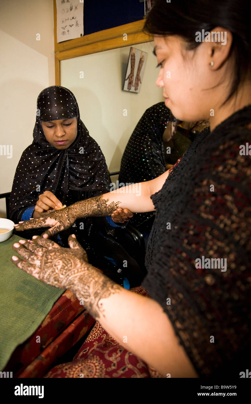A Muslim mahendi artist dabs the hands of her Rajastani client Stock ...