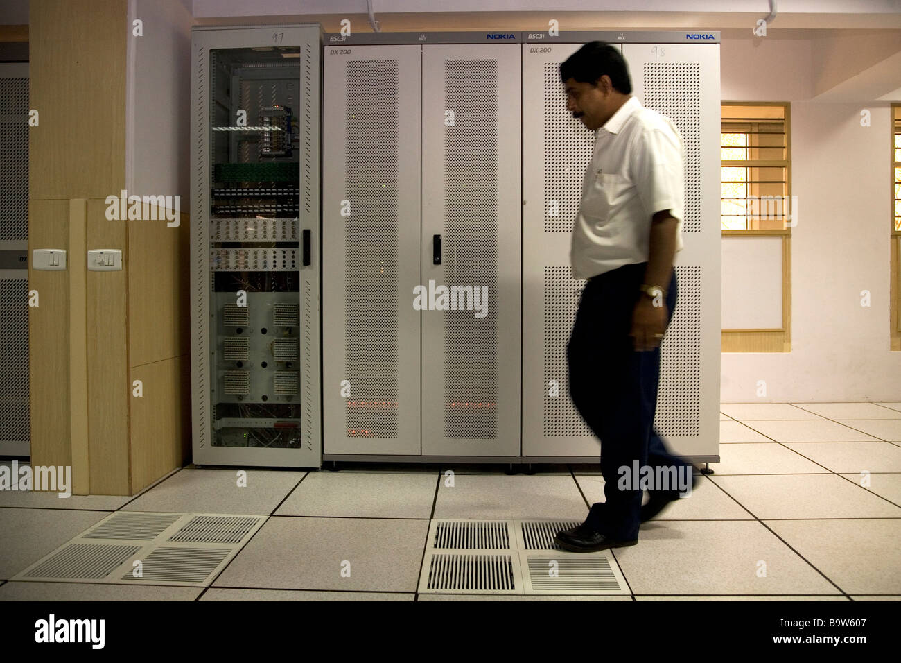 A man walks through an R&D lab in the office of an information ...