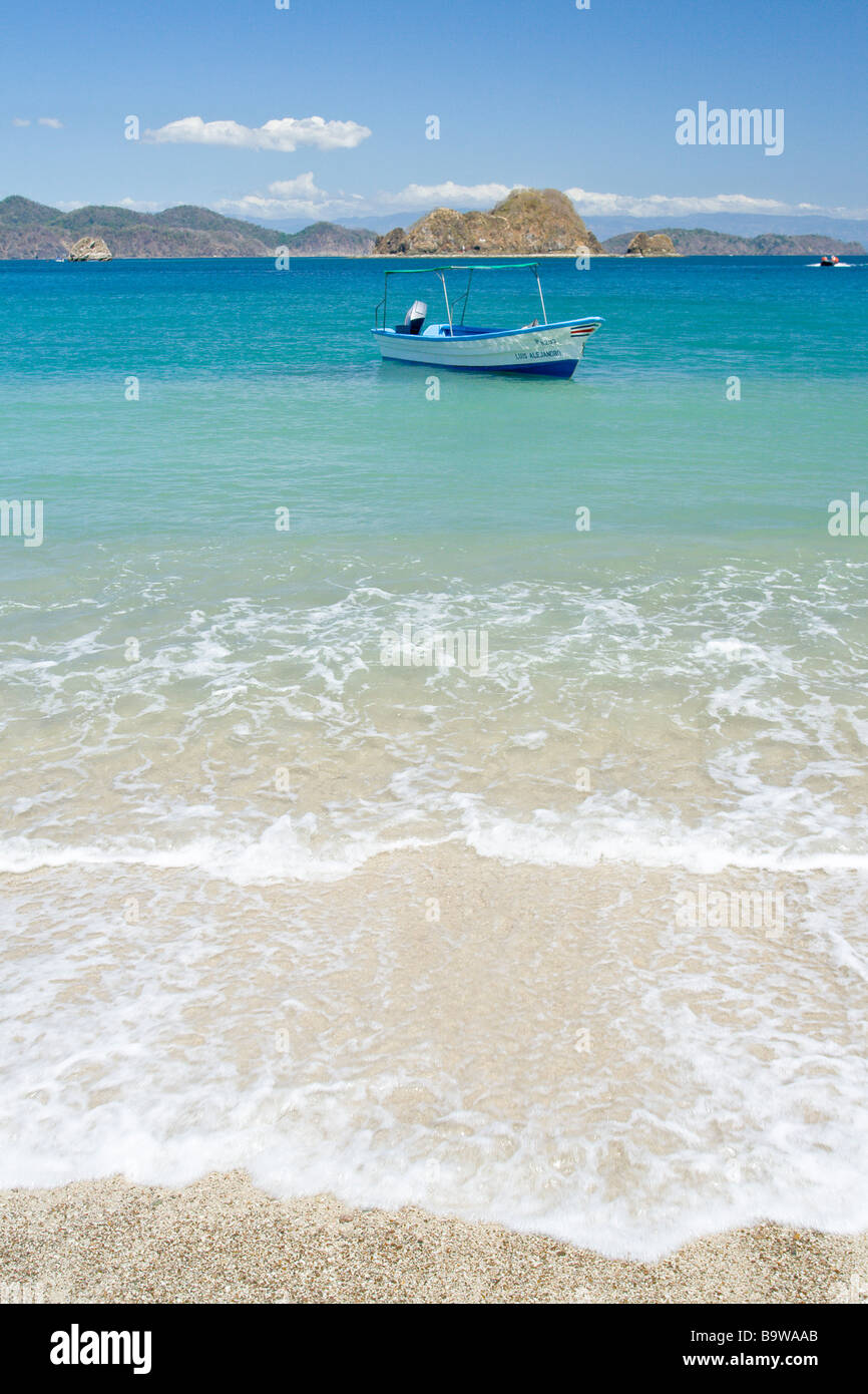 A beautiful beach of the isla tortuga with a small boat and beautiful ...