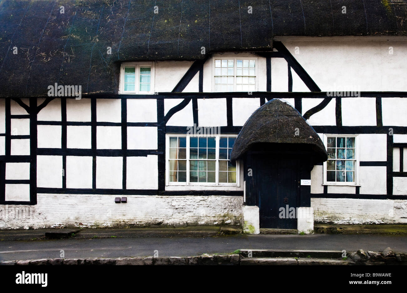 An old thatched timber framed Tudor cottage in the English village of ...