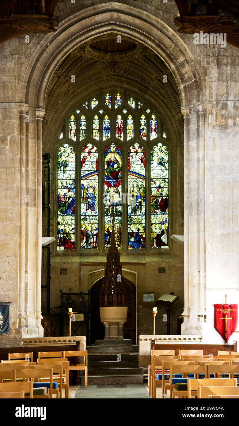 Font and stained glass window in St Johns Church in the English village ...
