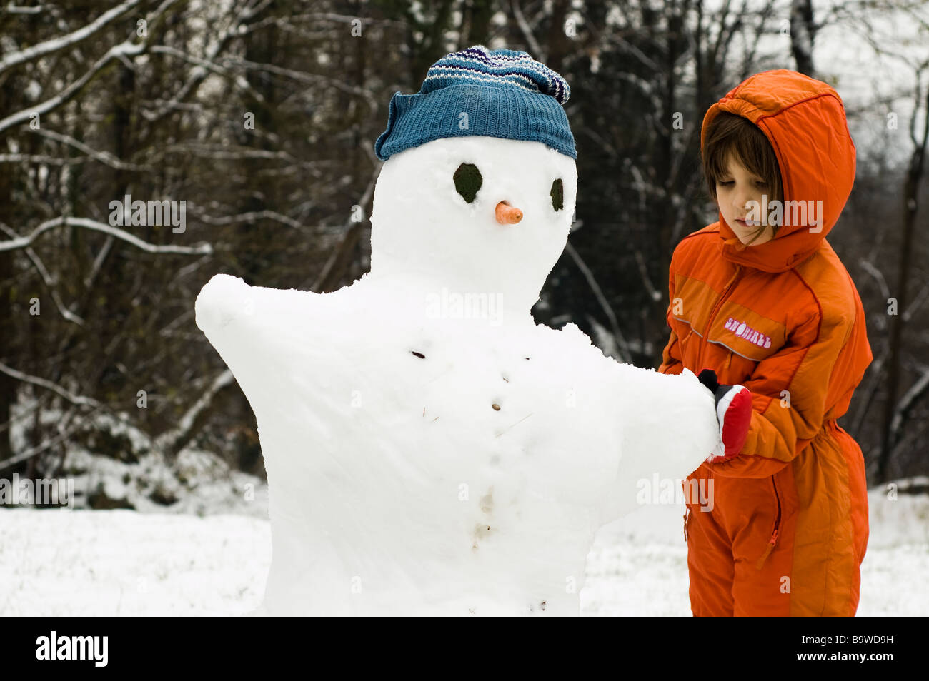 Snowman and girl Stock Photo - Alamy