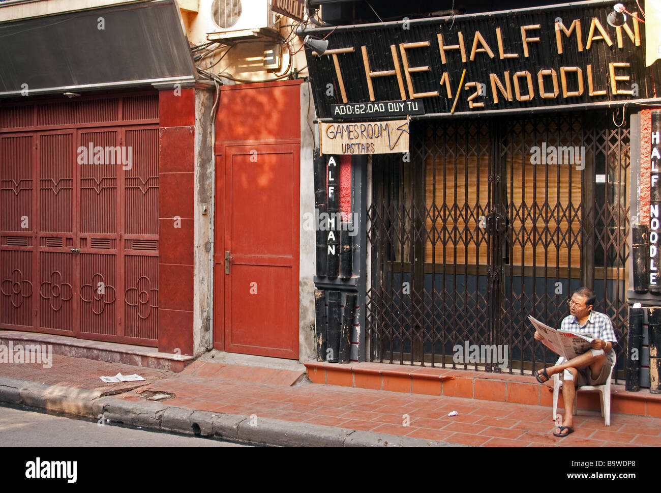 Vietnamese man relaxing and reading the morning newspaper before the ...