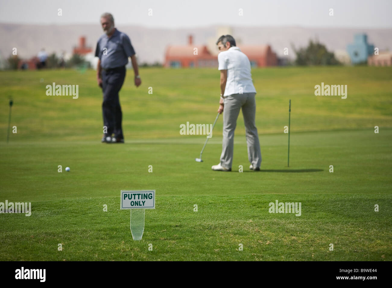 Golf players hi-res stock photography and images - Alamy