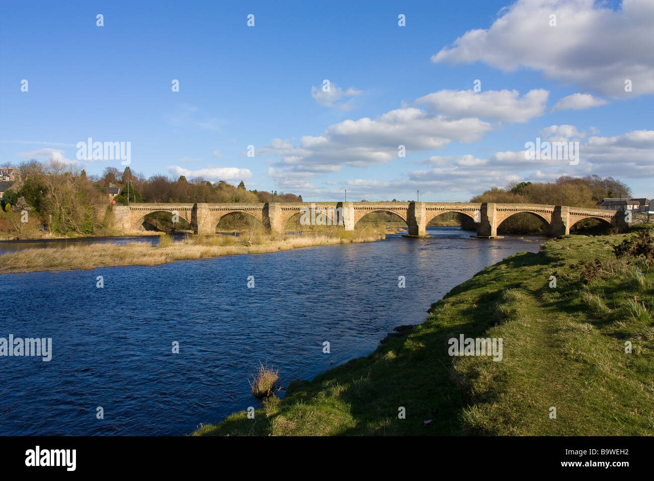 Wide landscape view of the historic old bridge spanning the slow moving ...