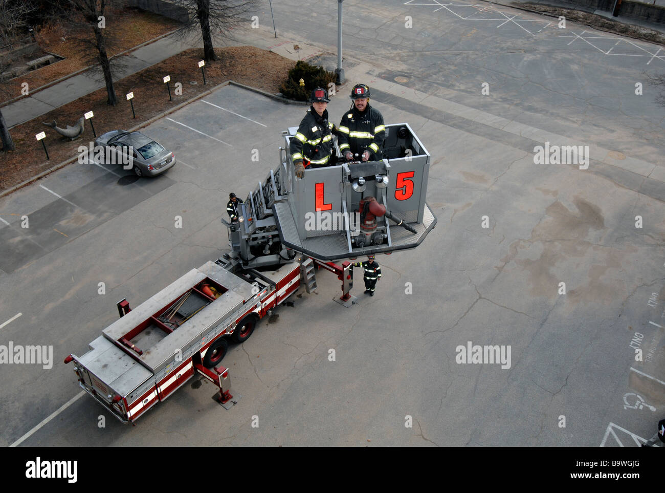 Firefighters train on bucket of ladder truck Stock Photo - Alamy