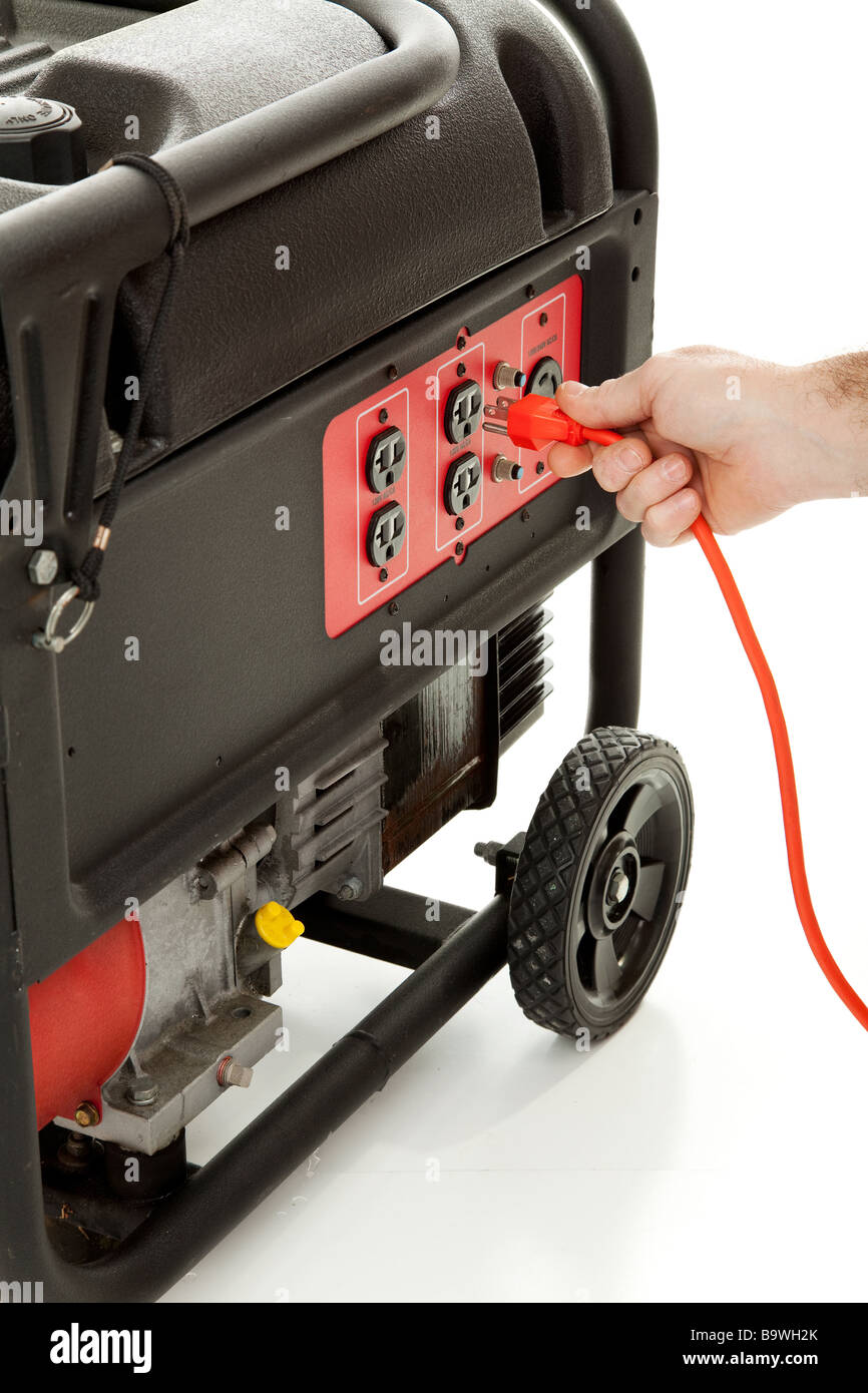 Someone plugging an extension cord into a portable gasoline generator ...