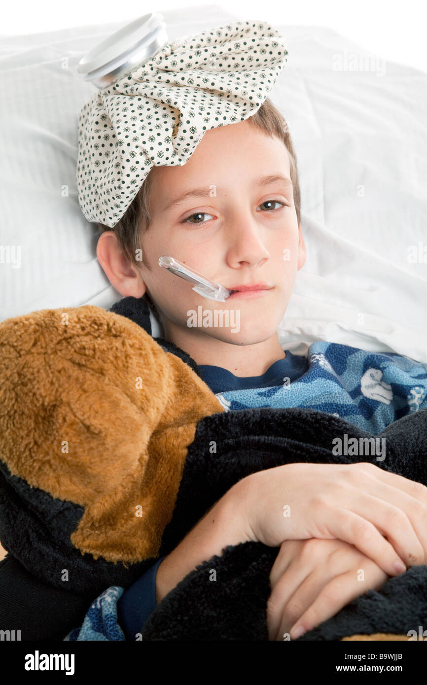 Sick little boy home from school with a fever Vertical view Stock Photo ...