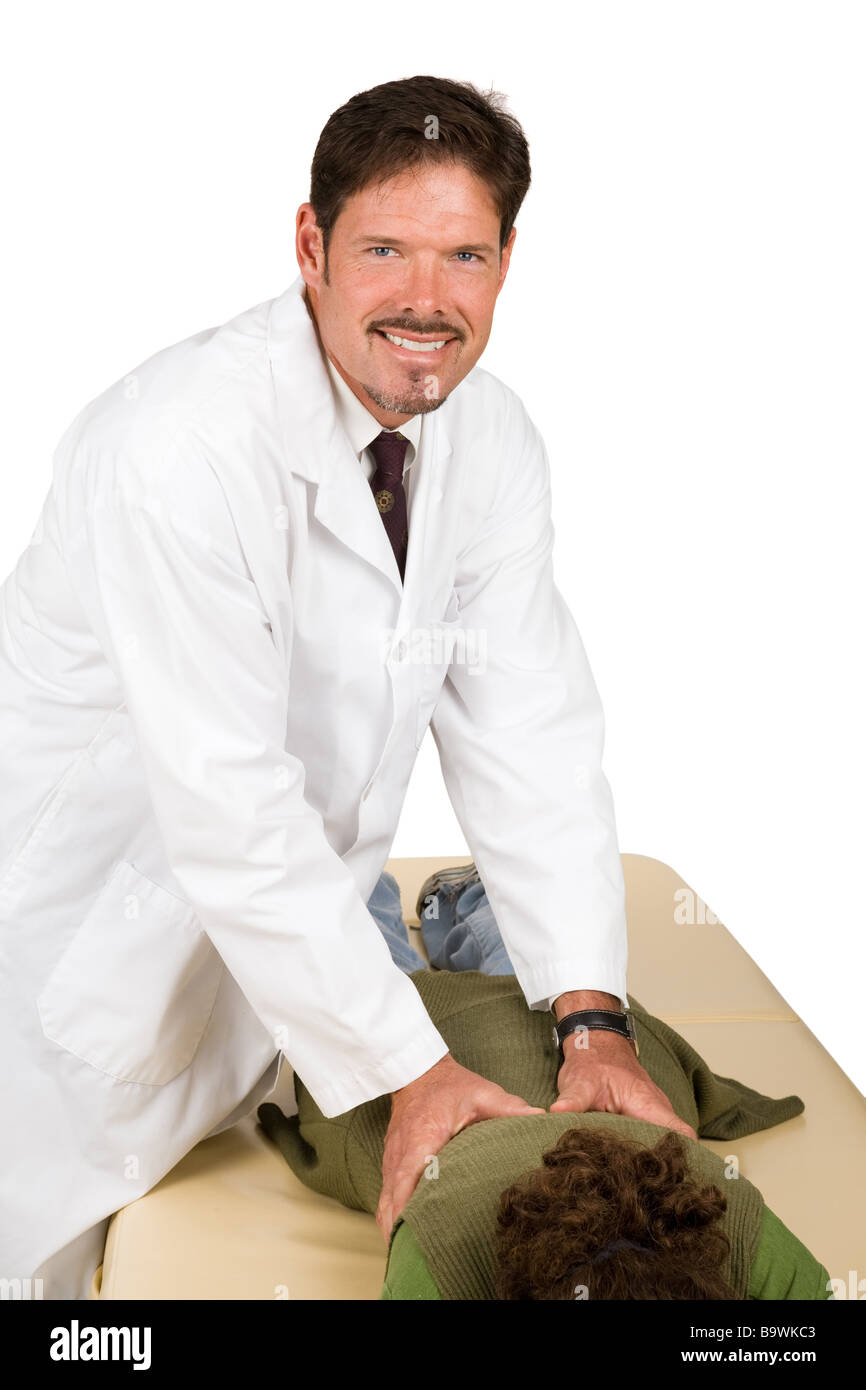 Handsome chiropractor smiles as he adjusts a patient Isolated on white ...