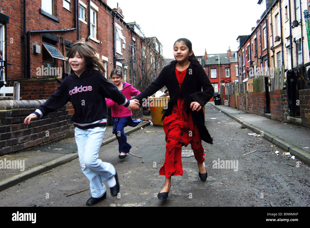 A mixed group of girls play out on the street Beeston Leeds Stock Photo ...