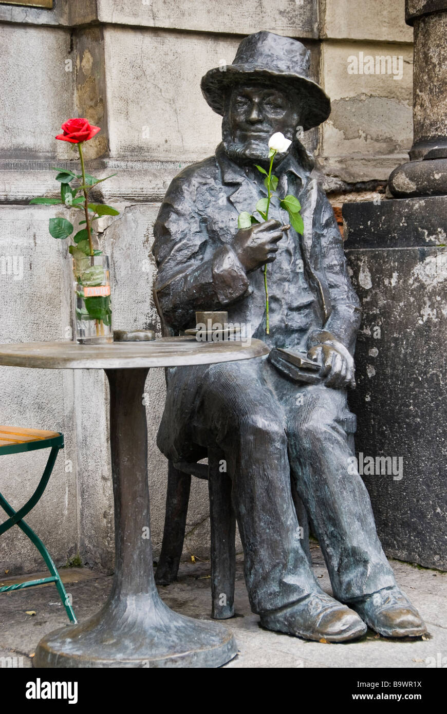 Statue of a man drinking coffee in the streets of Krakow city center ...