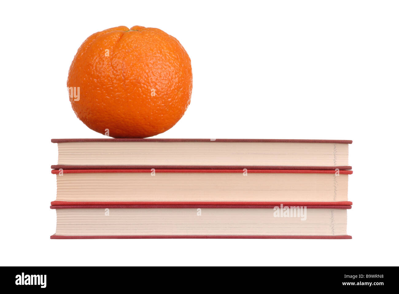 Books stack and orange isolated on white background Stock Photo - Alamy