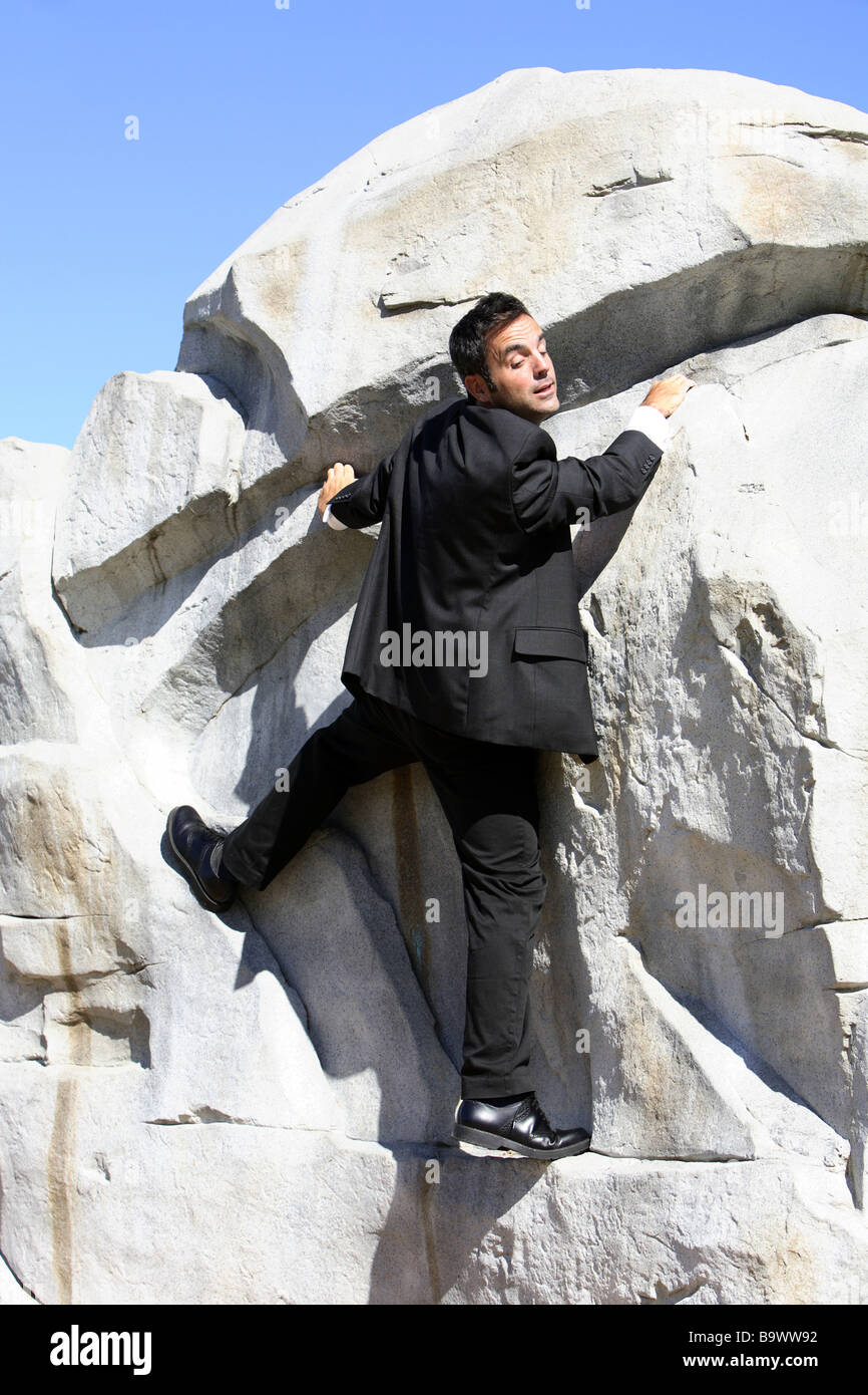 Businessman rock climbing Stock Photo - Alamy