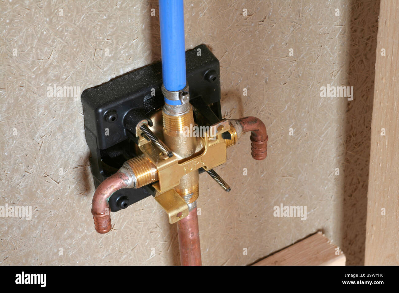 Partially installed plumbing on modular bath in new house construction ...