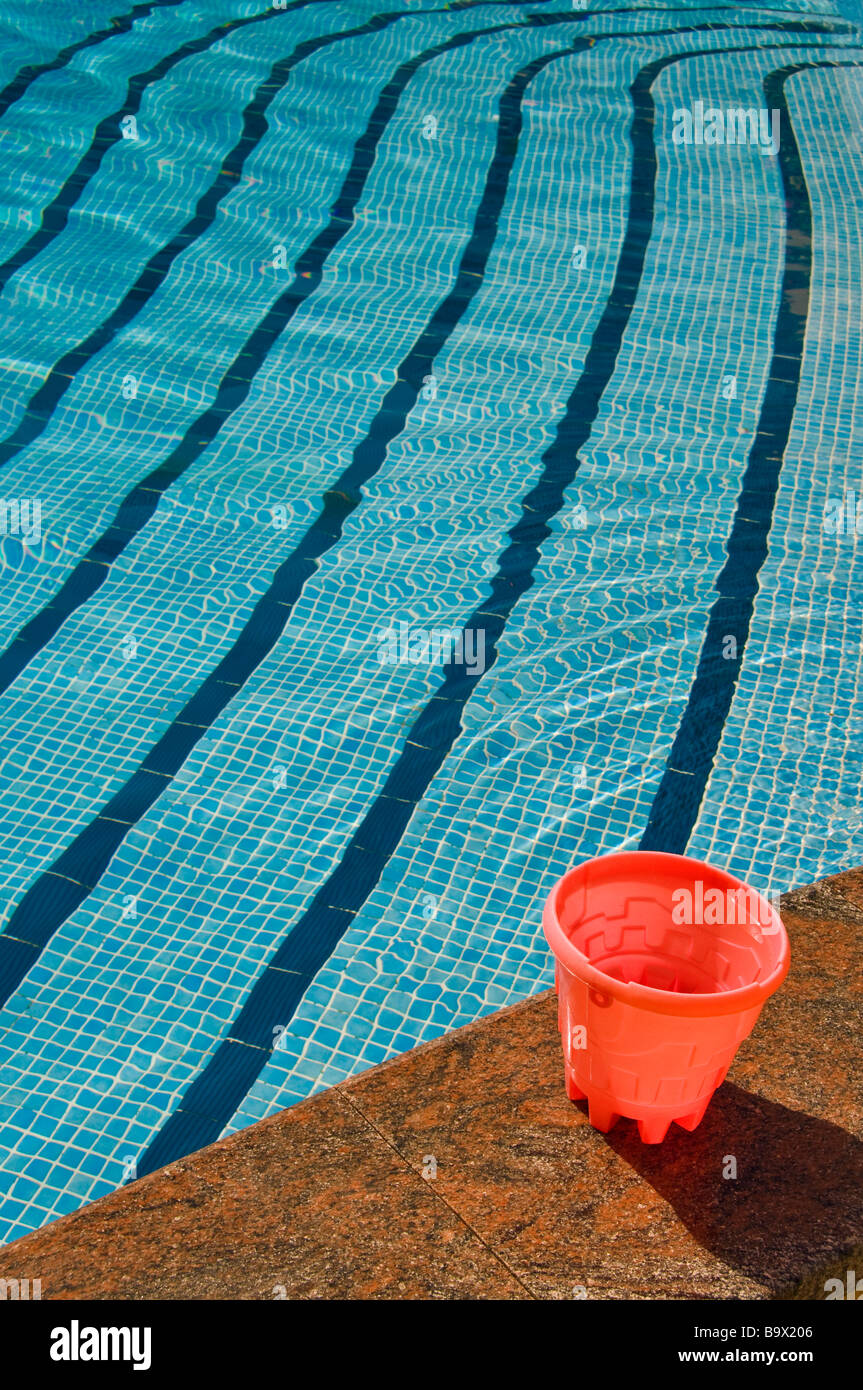 Bucket in front of a swimming pool Stock Photo - Alamy