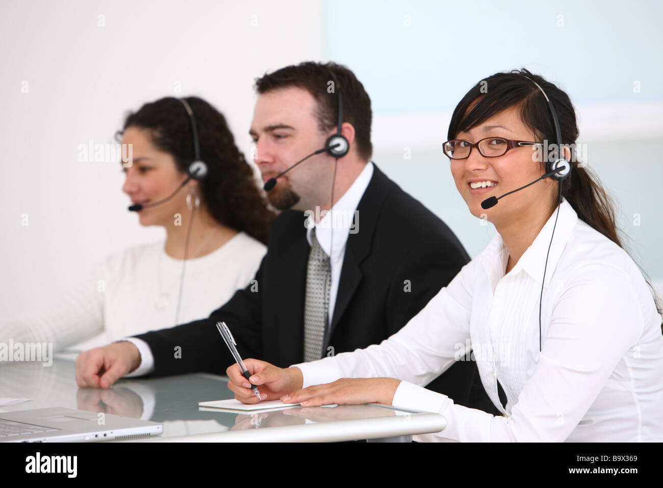 Three customer service people Stock Photo - Alamy