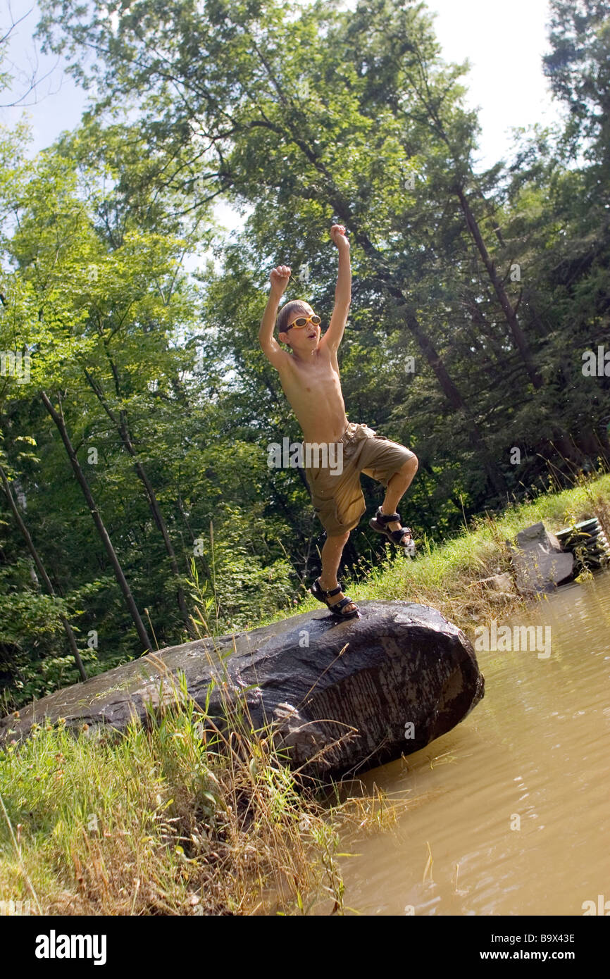 Boy jumping into pond hi-res stock photography and images - Alamy