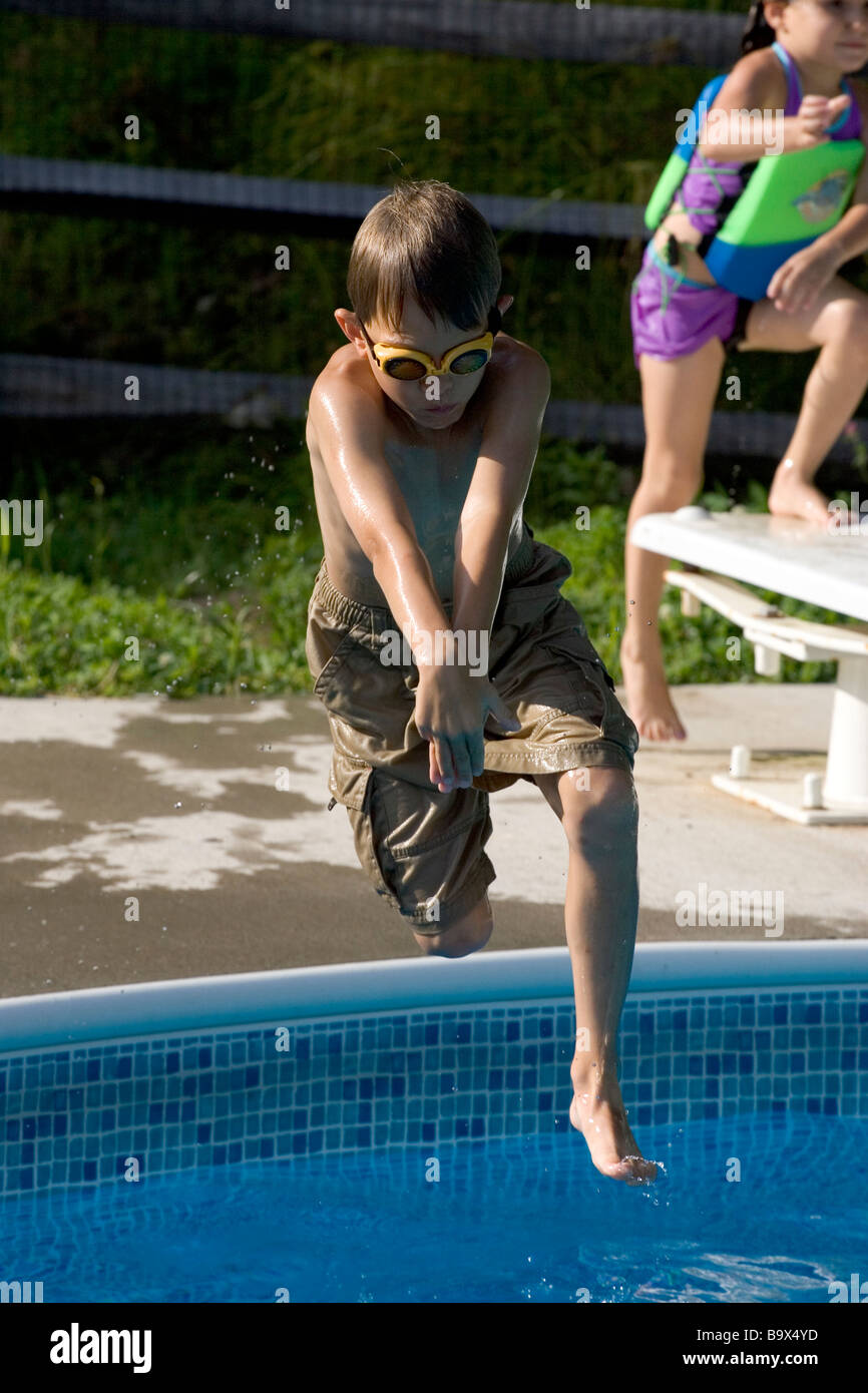 9 year old boy diving into a swimming pool Stock Photo - Alamy
