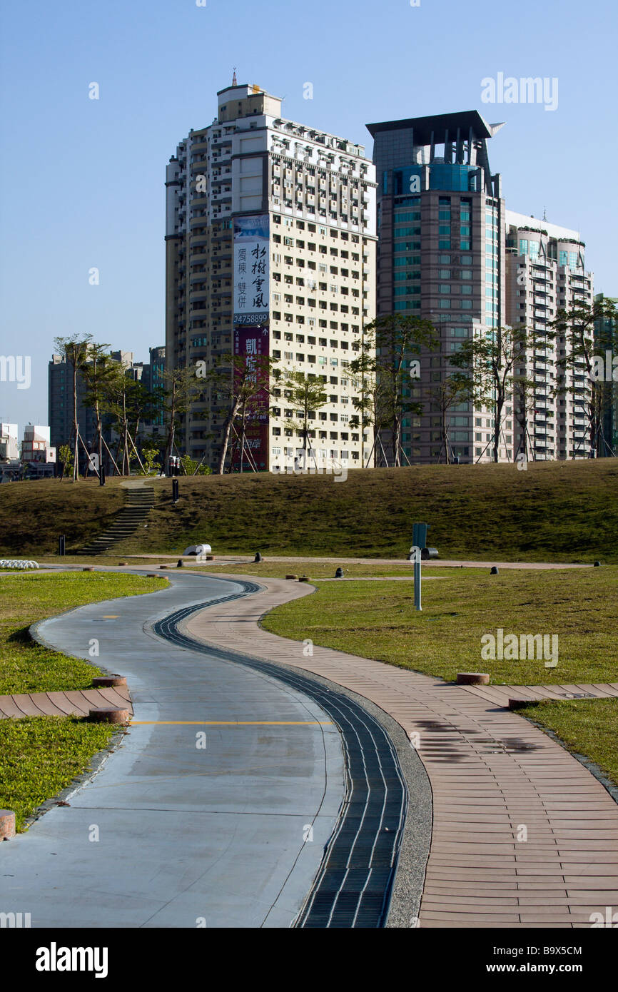 S-shape curve footpath in grass at park, buildings on background ...