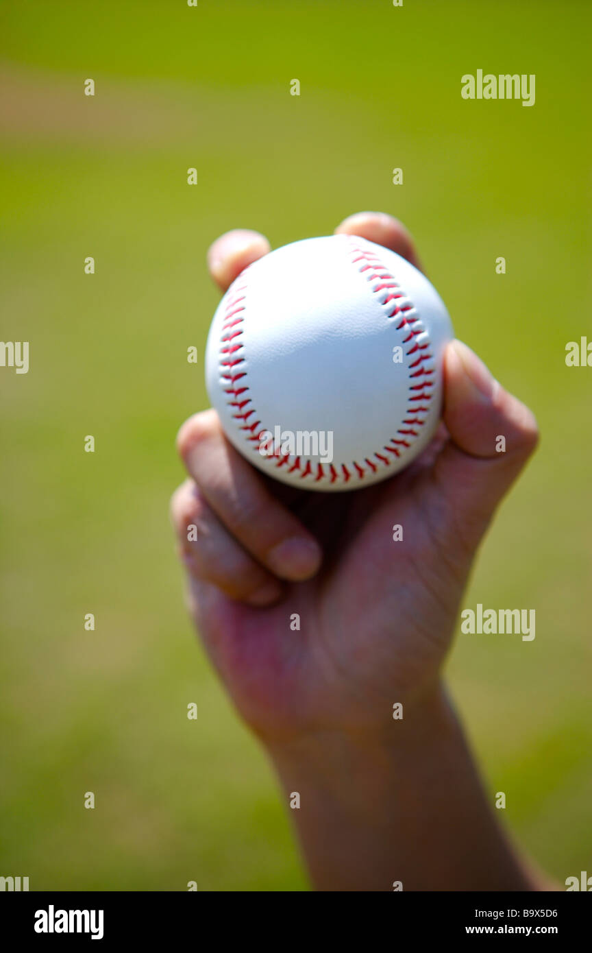 Hand holding baseball Stock Photo - Alamy