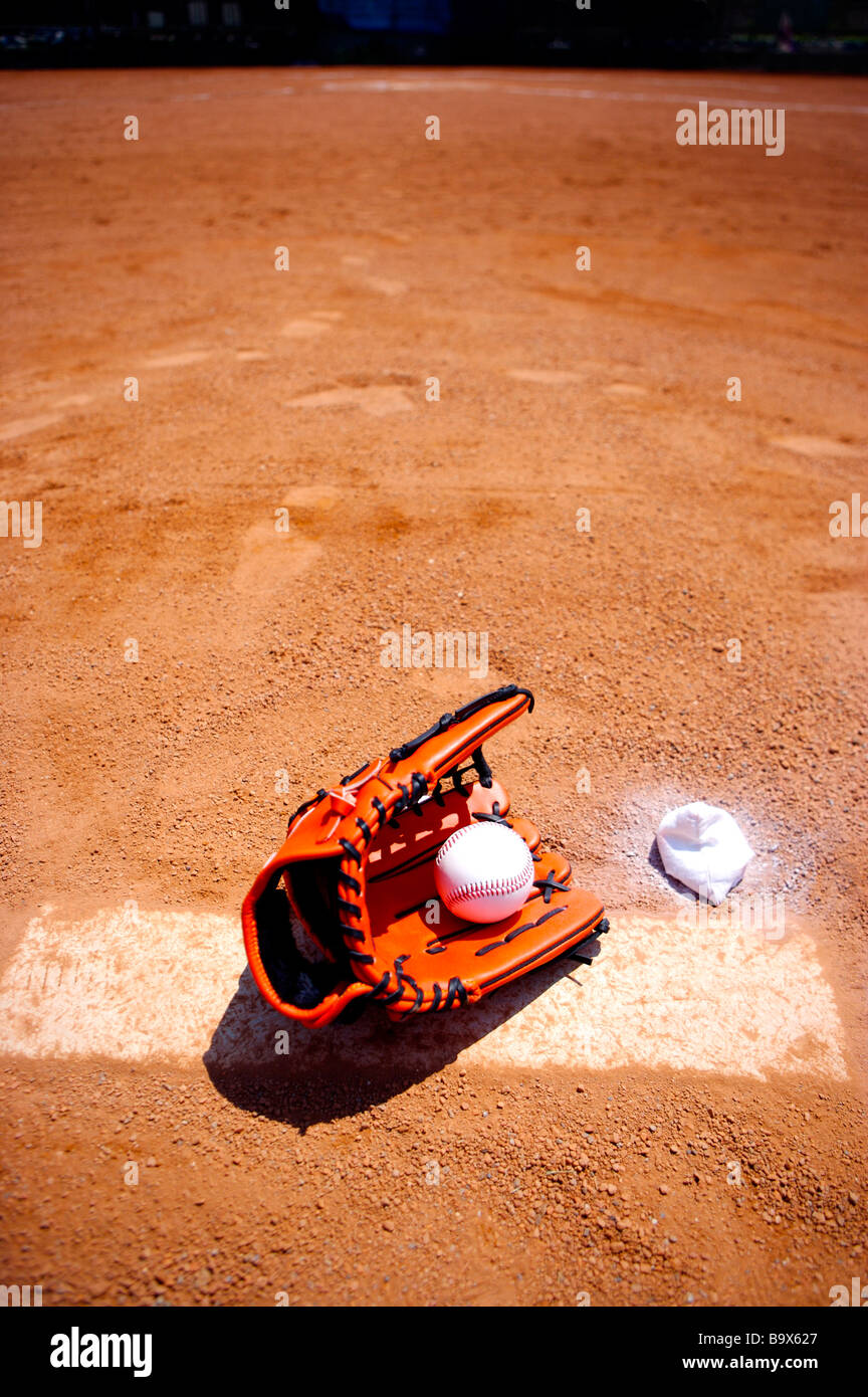 Close up of baseball glove and ball on base Stock Photo - Alamy