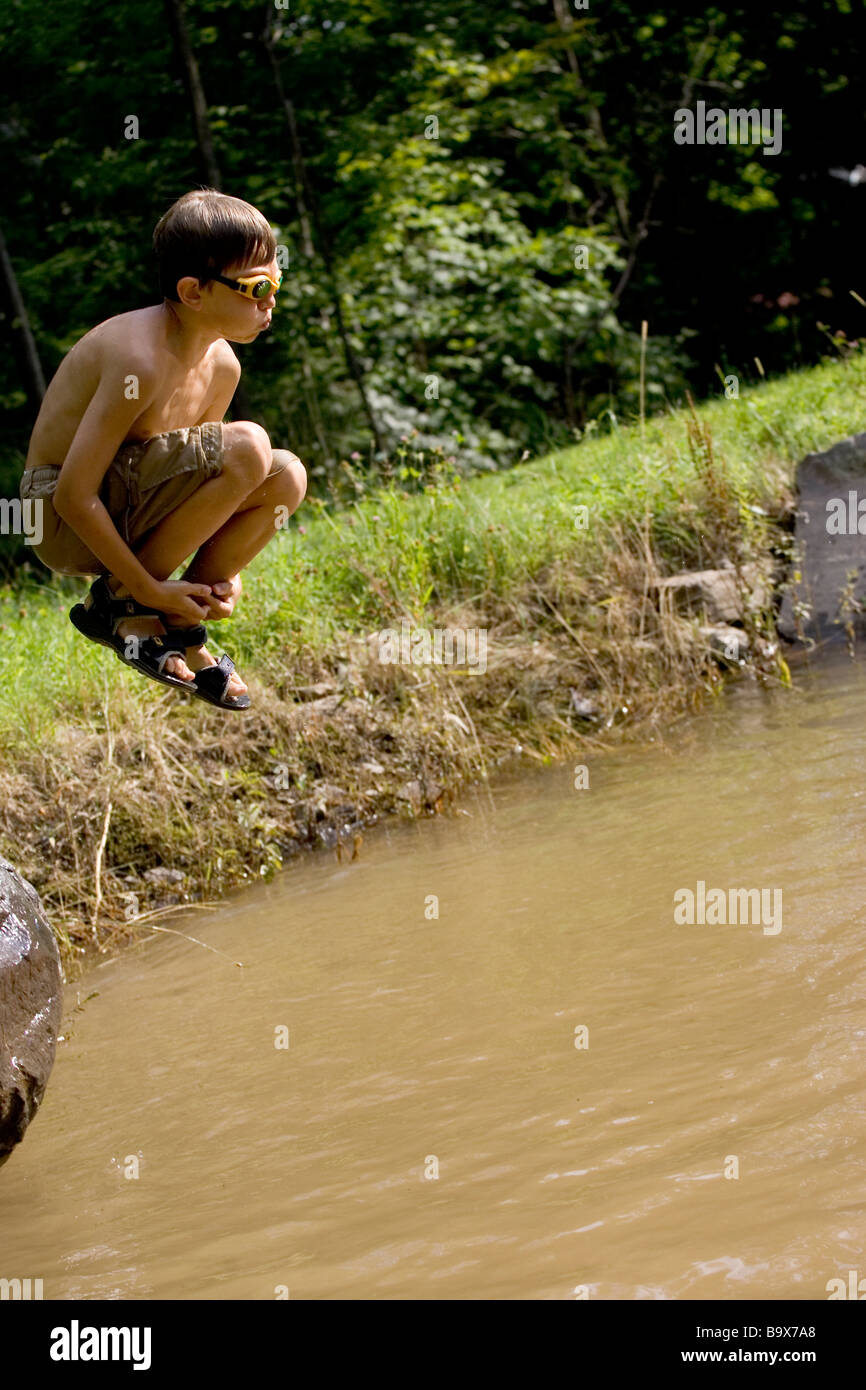 Boy jumping into pond hi-res stock photography and images - Alamy