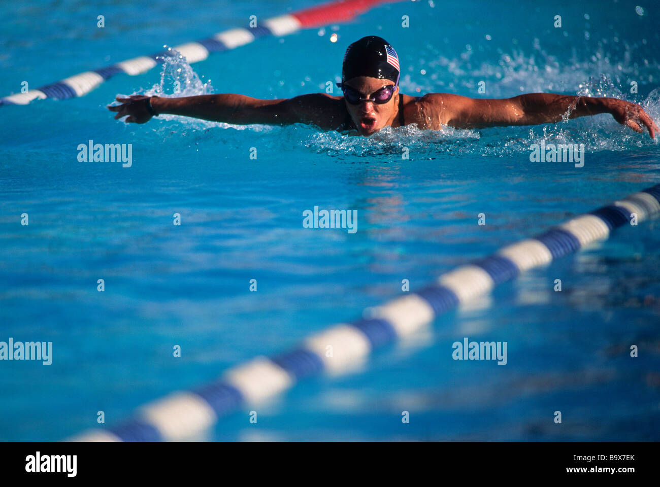 Female swimmer competing in a butterfly race Stock Photo - Alamy