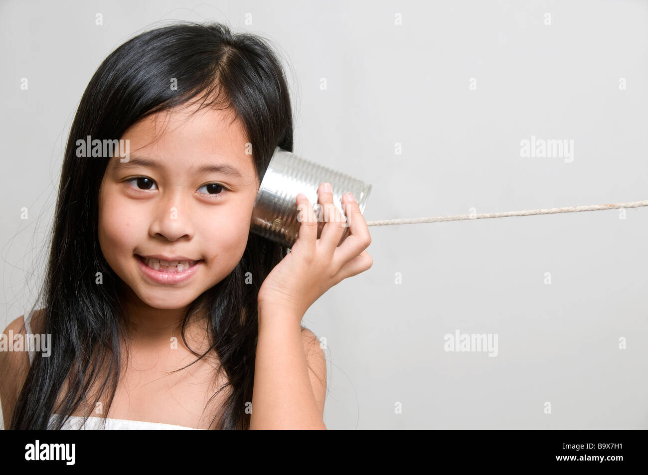young Asian child laying down and looking at camera Stock Photo - Alamy