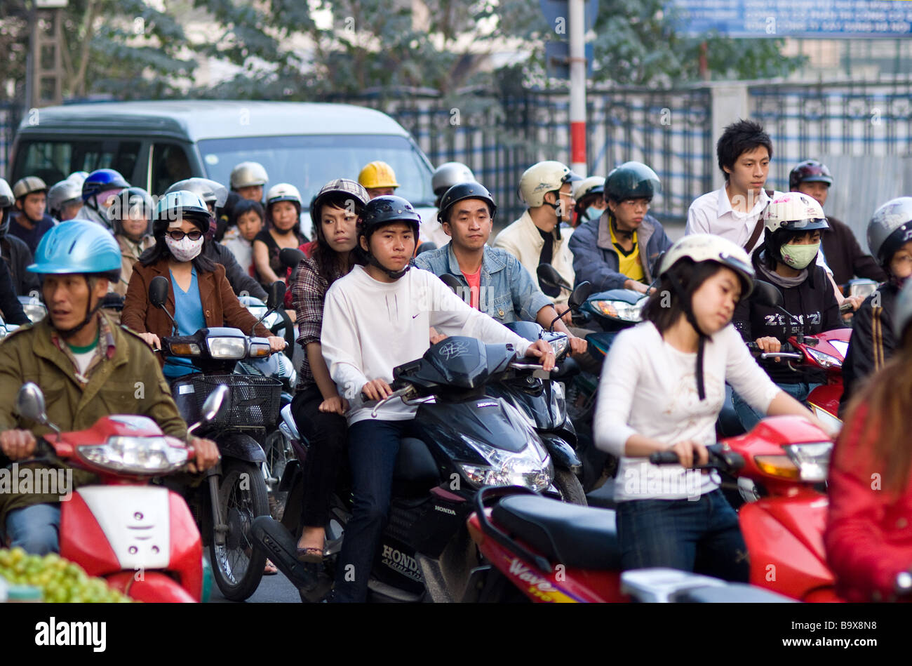 Crowd on motorbikes waiting at a red light crossing in Hanoi Vietnam ...