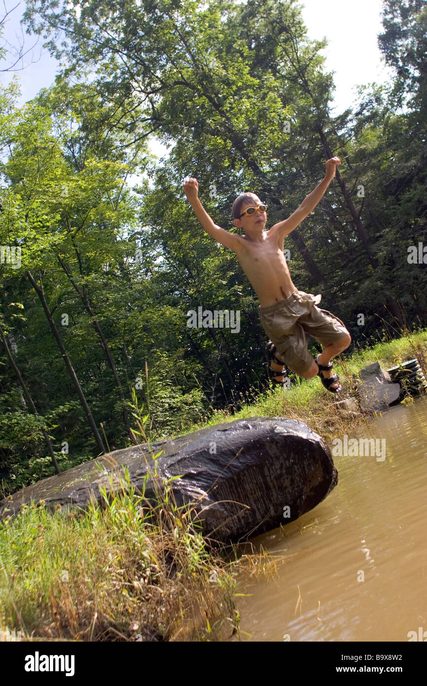 Children jumping off a rock hi-res stock photography and images - Alamy